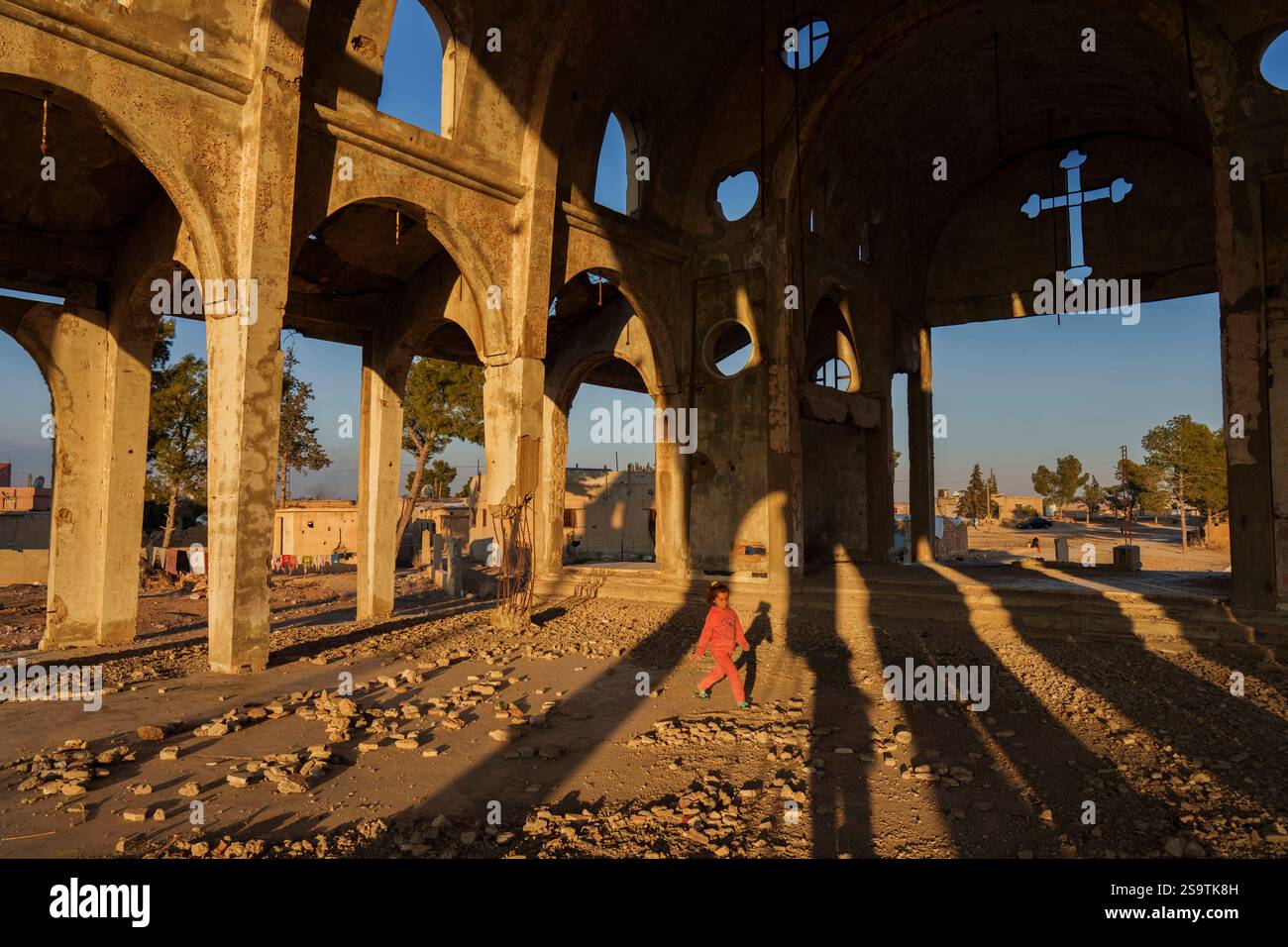 A girl walks through the Virgin Mary Church, which was destroyed by the ...