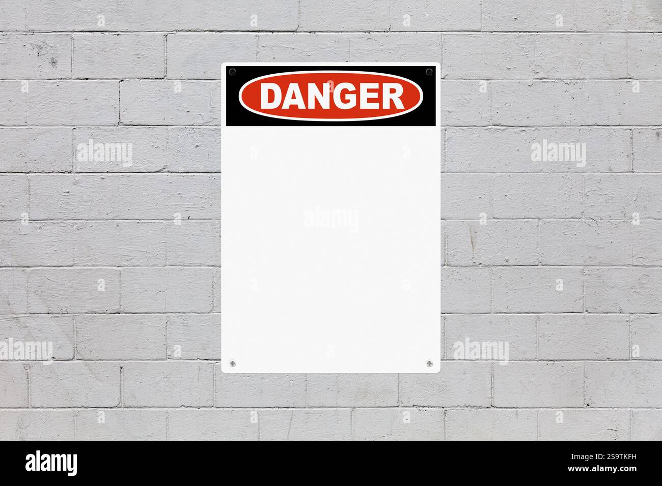 Blank danger sign screwed to a cinder block wall to warn about a health ...