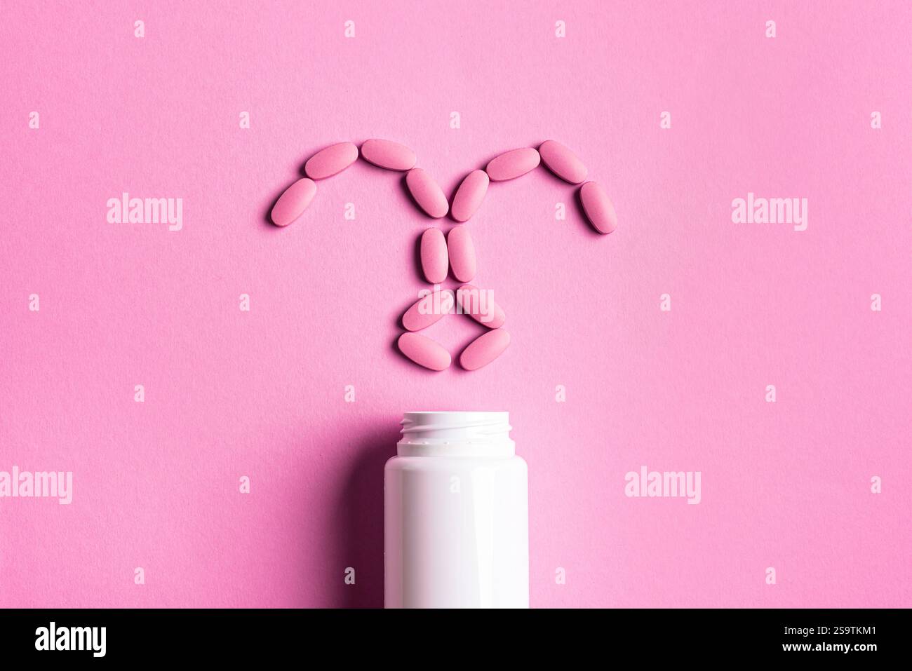 Uterus made of pink pills, minimal concept of female health on pink ...
