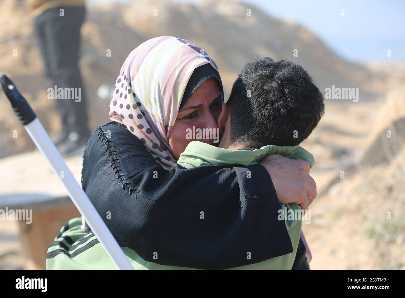 Gaza. 27th Jan, 2025. Displaced people on their way home embrace each ...