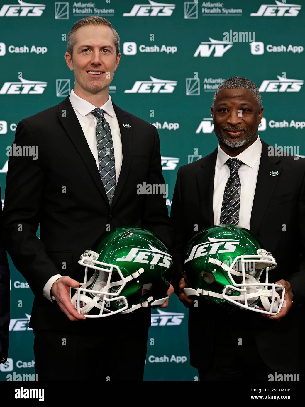 New York Jets new head coach Aaron Glenn, right, and general manager Darren Mougey pose for a ...