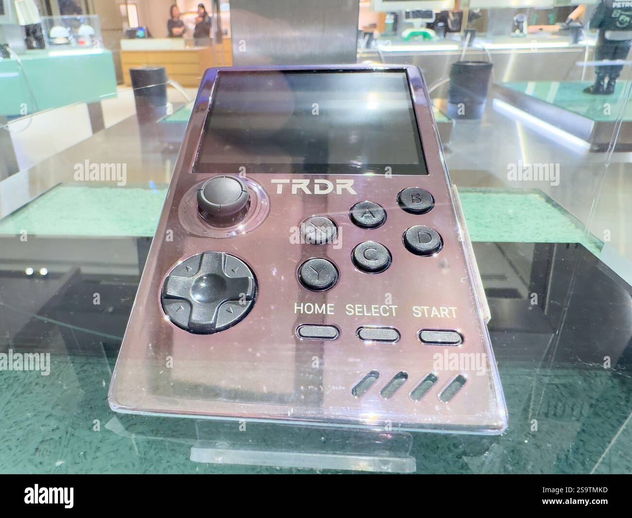 Nostalgic handheld gaming device displayed at a modern tech exhibition ...