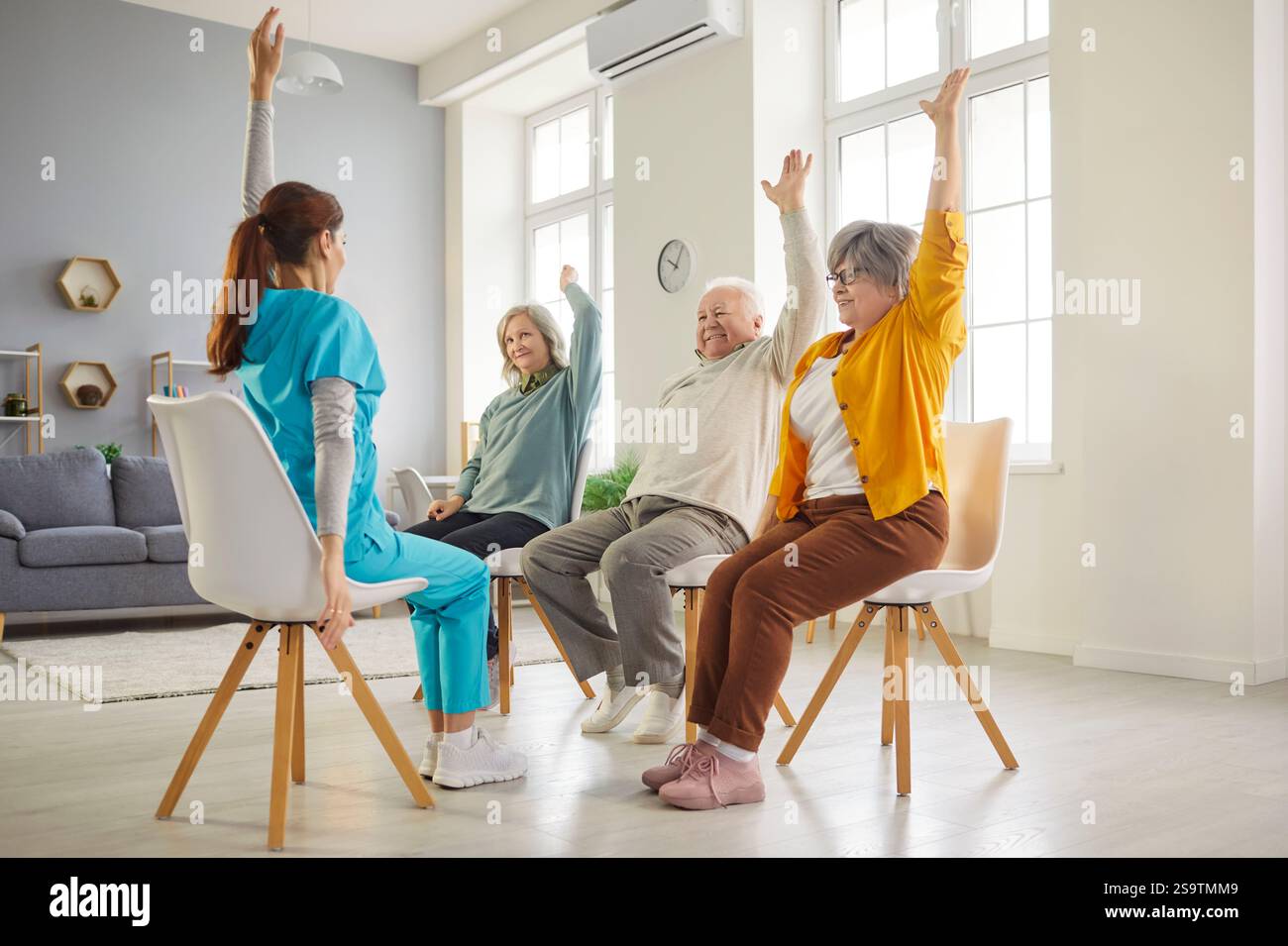 Nurse from reabilitation clinic shows physical exercises for mature ...