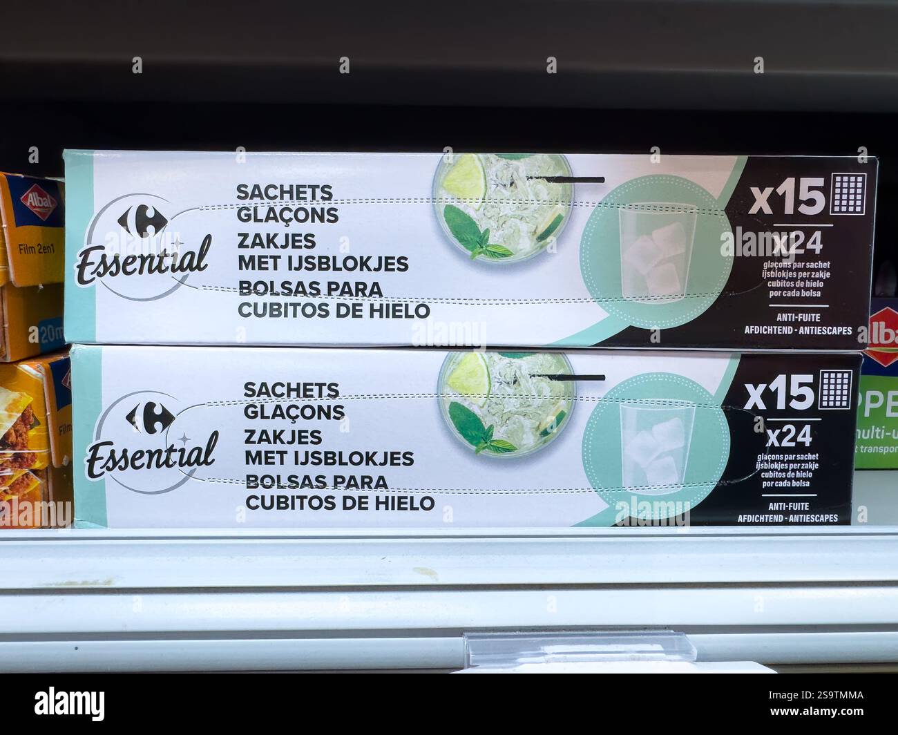 Essential ice cube bags displayed on a retail shelf in a grocery store ...