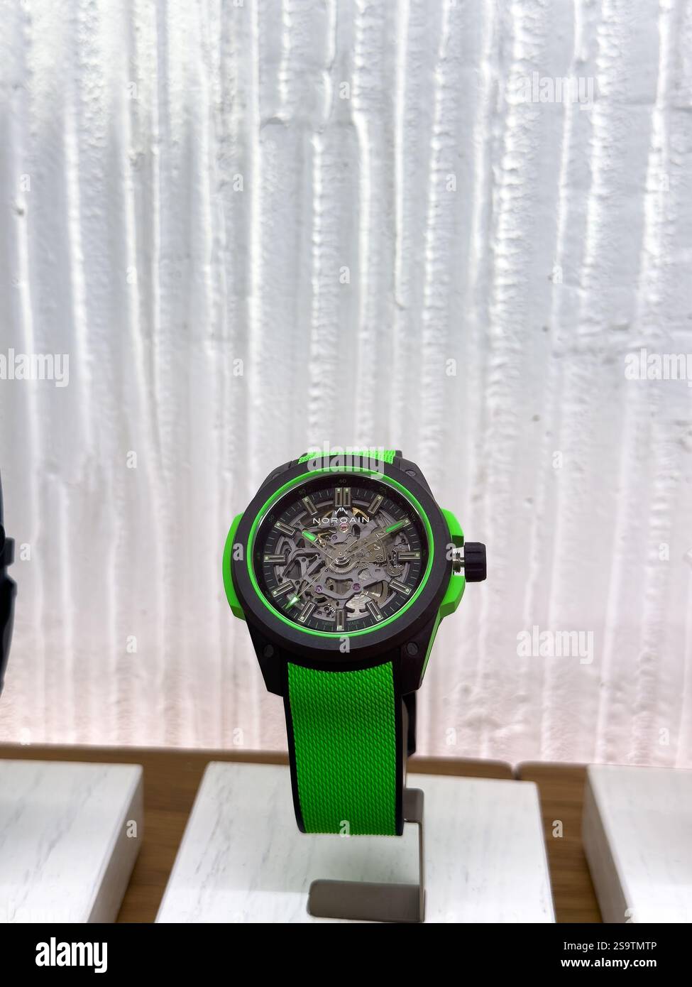 Unique green watch highlighting intricate design in modern display ...