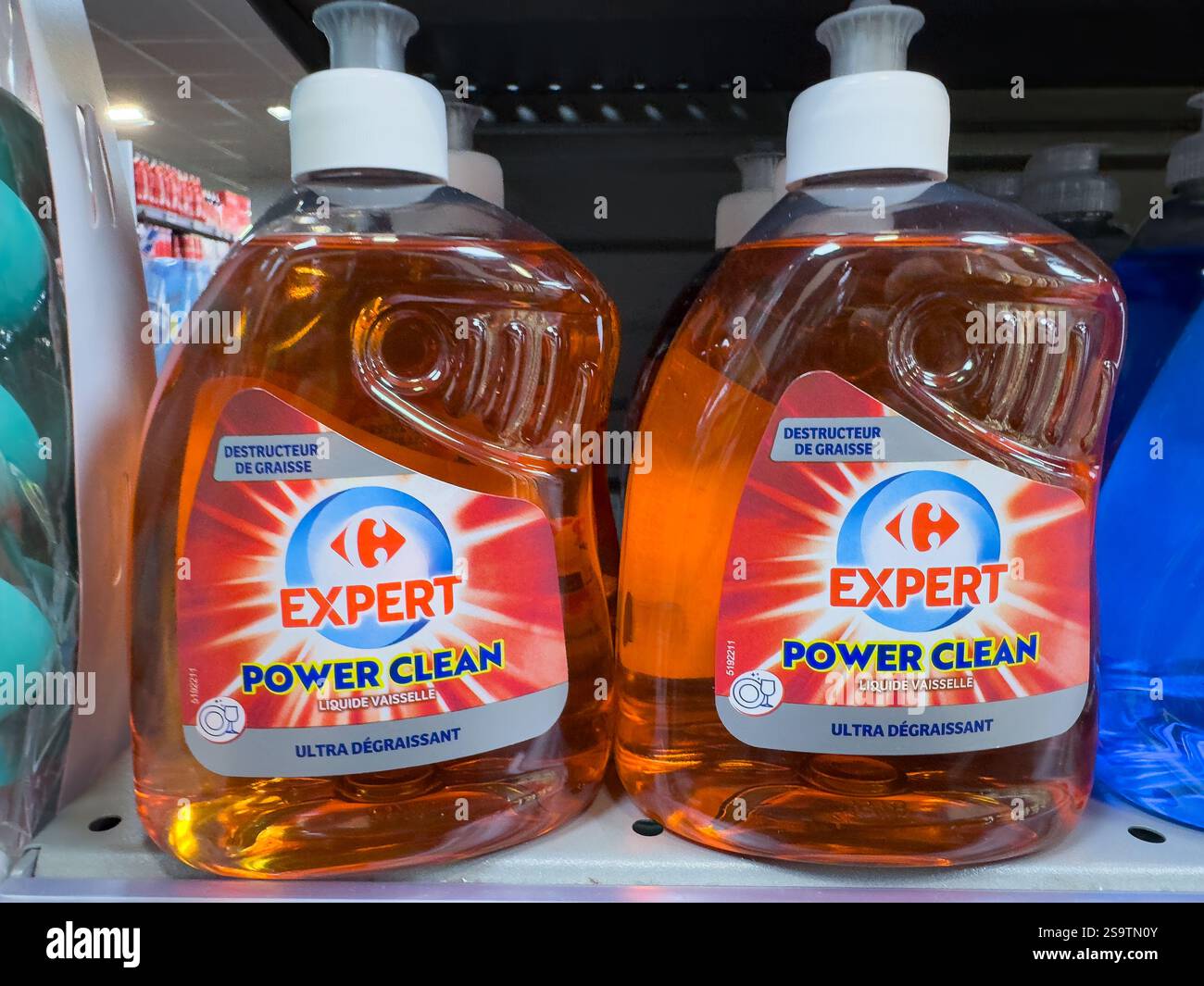 Detergent bottles showcase vibrant colors in a bustling supermarket ...