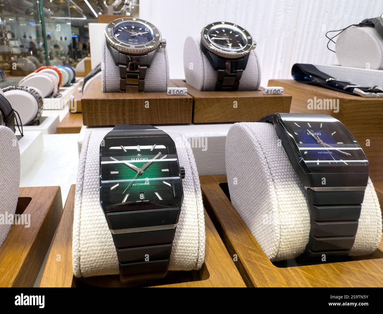 Elegant timepieces displayed in a modern retail space at a busy market ...