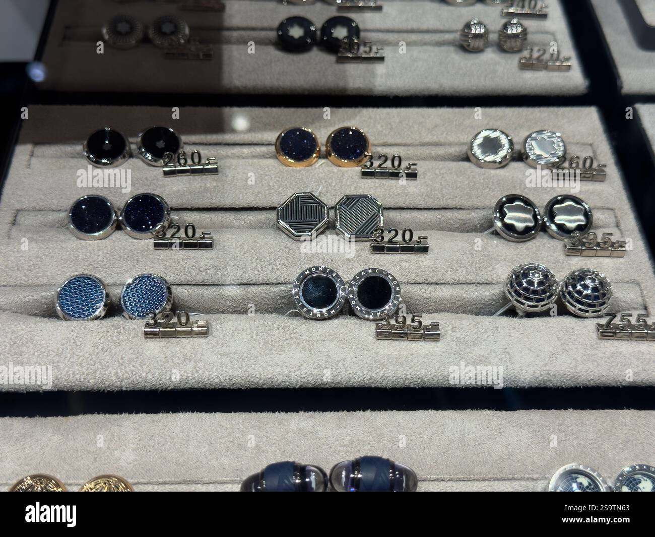 Stylish cufflinks showcased in an elegant display at a jewelry store ...
