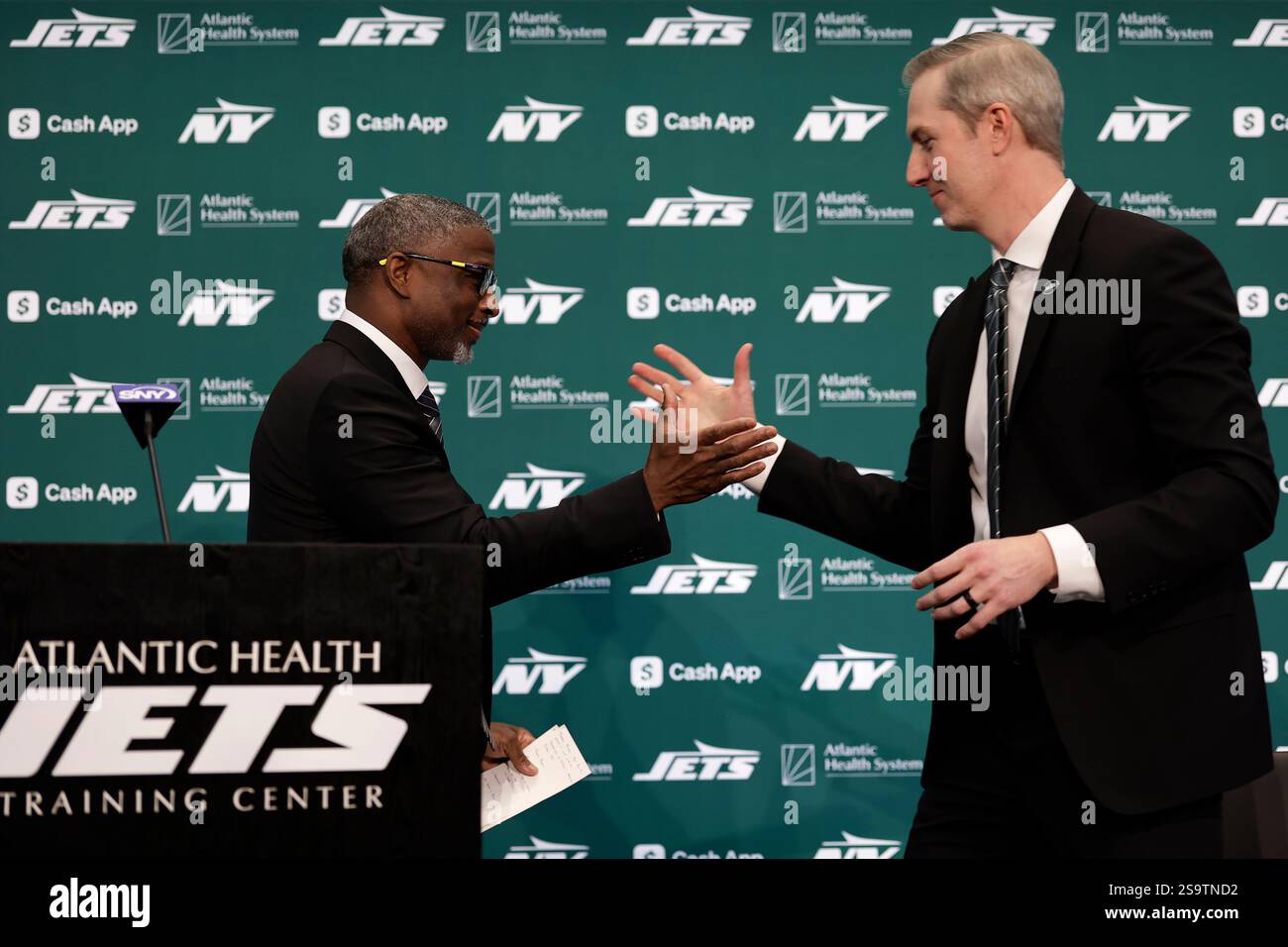 New York Jets new head coach Aaron Glenn, left, shakes hands with ...
