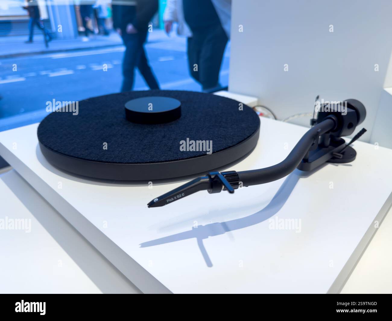 Modern turntable showcased in a lively urban setting during late ...