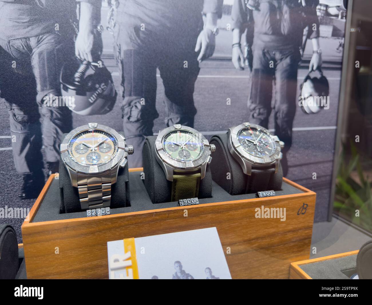 Luxury watches displayed in an elegant showcase with a military ...