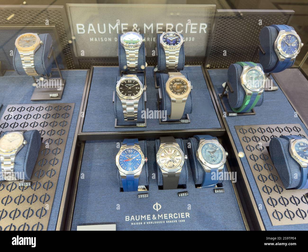 Stylish luxury watches displayed at a boutique in an upscale shopping ...