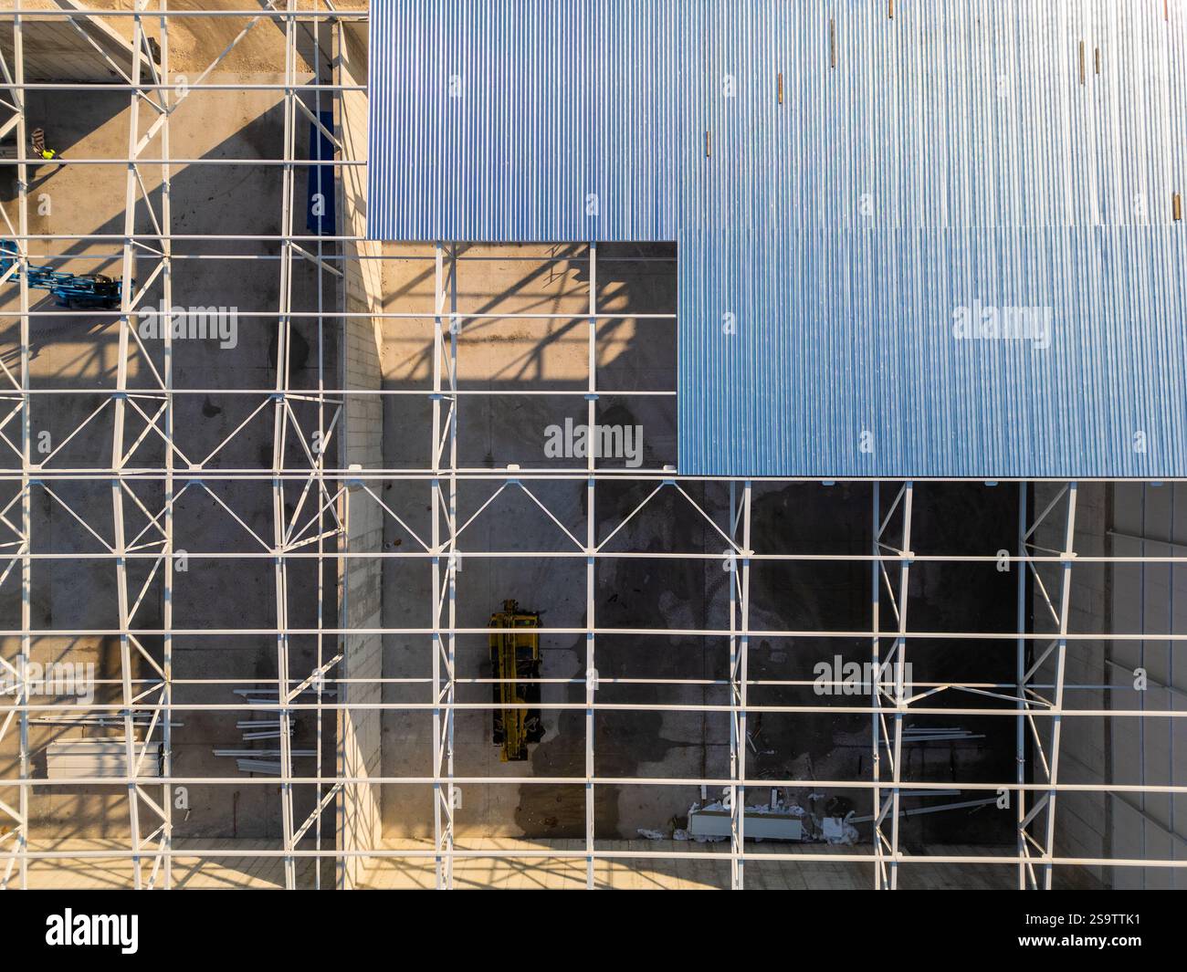 A construction site with a partially built warehouse featuring a steel ...