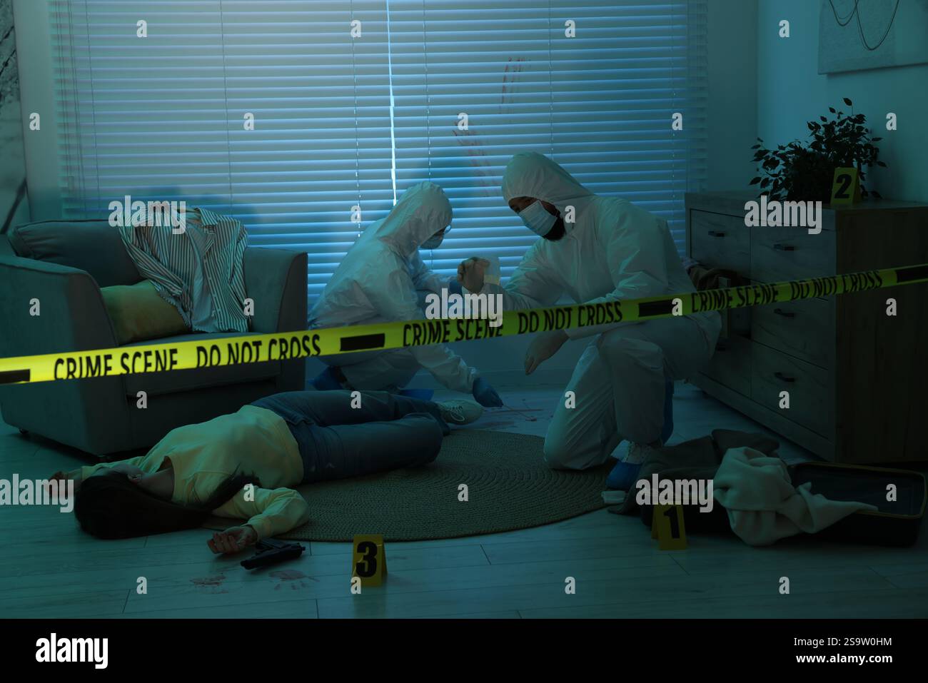 Forensic experts working at crime scene with dead woman's body indoors ...