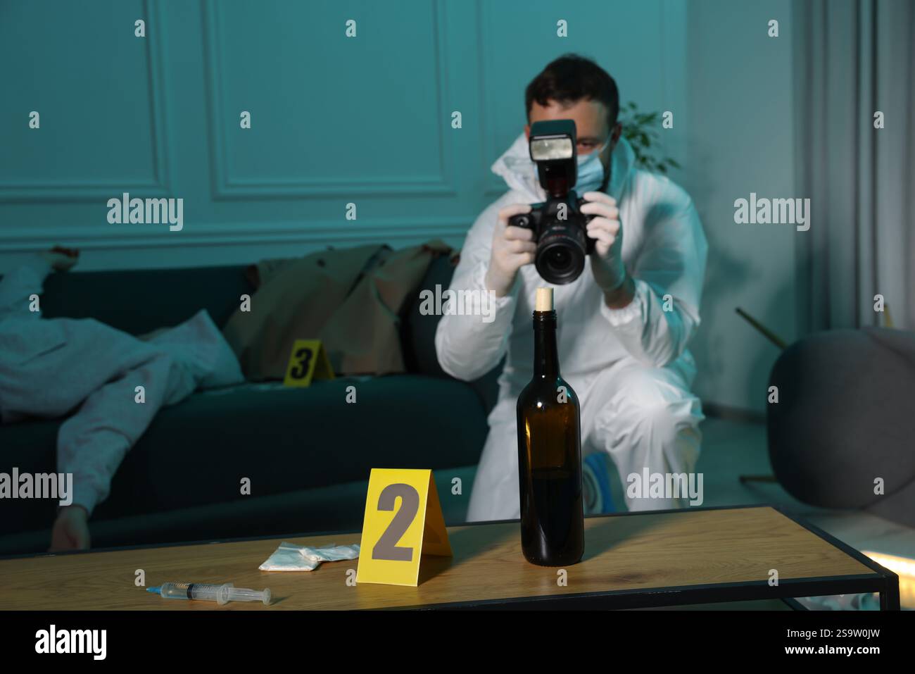 Forensic expert with camera working at crime scene and dead woman's ...