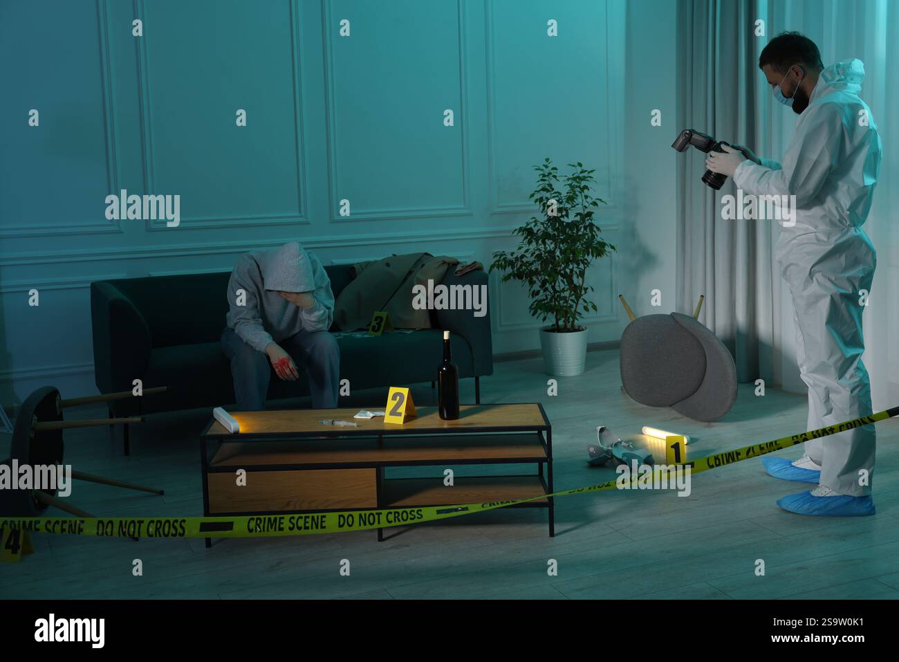 Forensic expert with camera working and victim at crime scene indoors ...