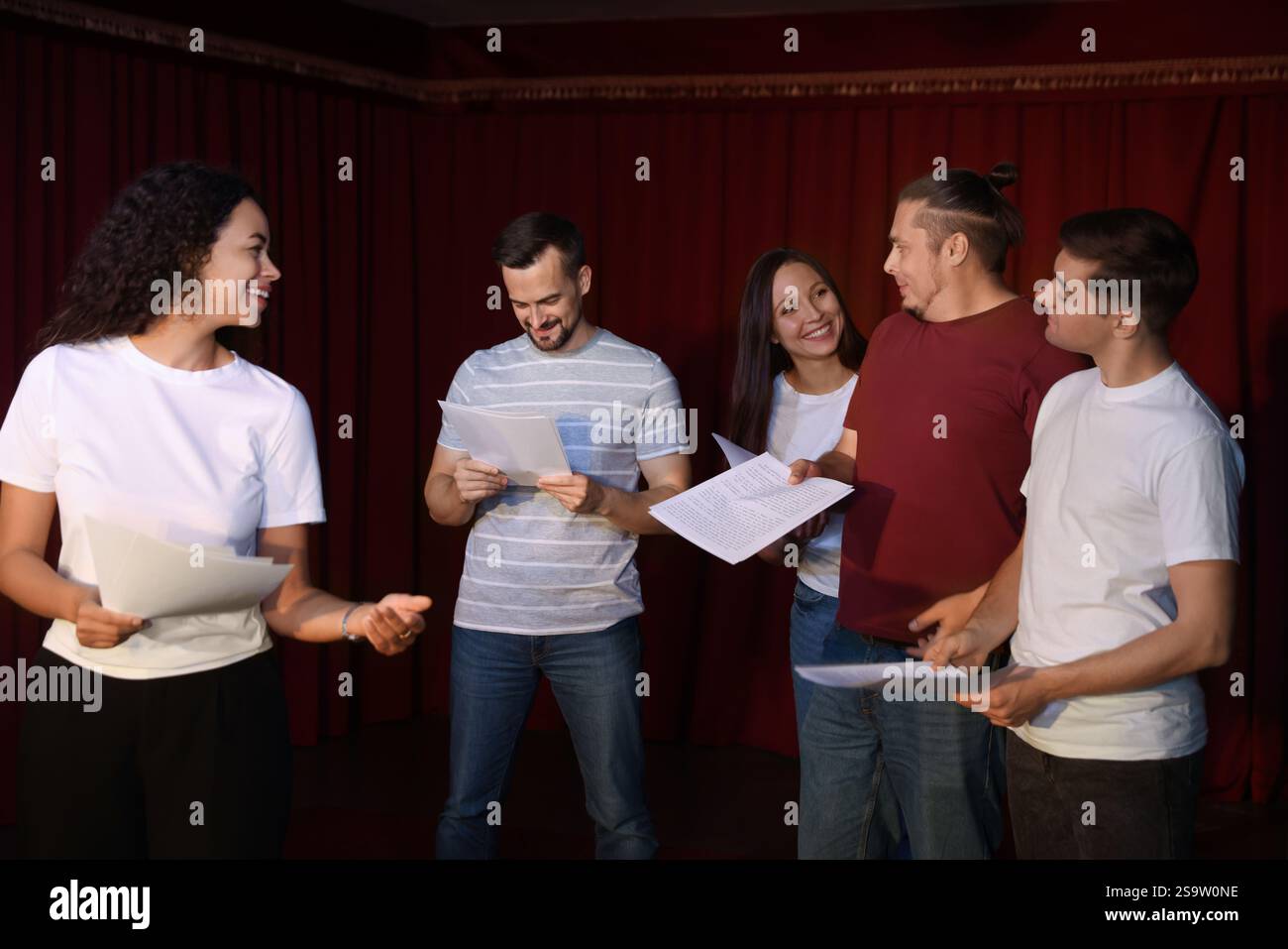 Professional actors with their scripts rehearsing in theatre Stock ...