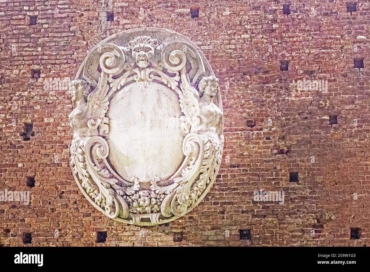 stone symbol of the city on the stone wall of the castle Stock Photo ...