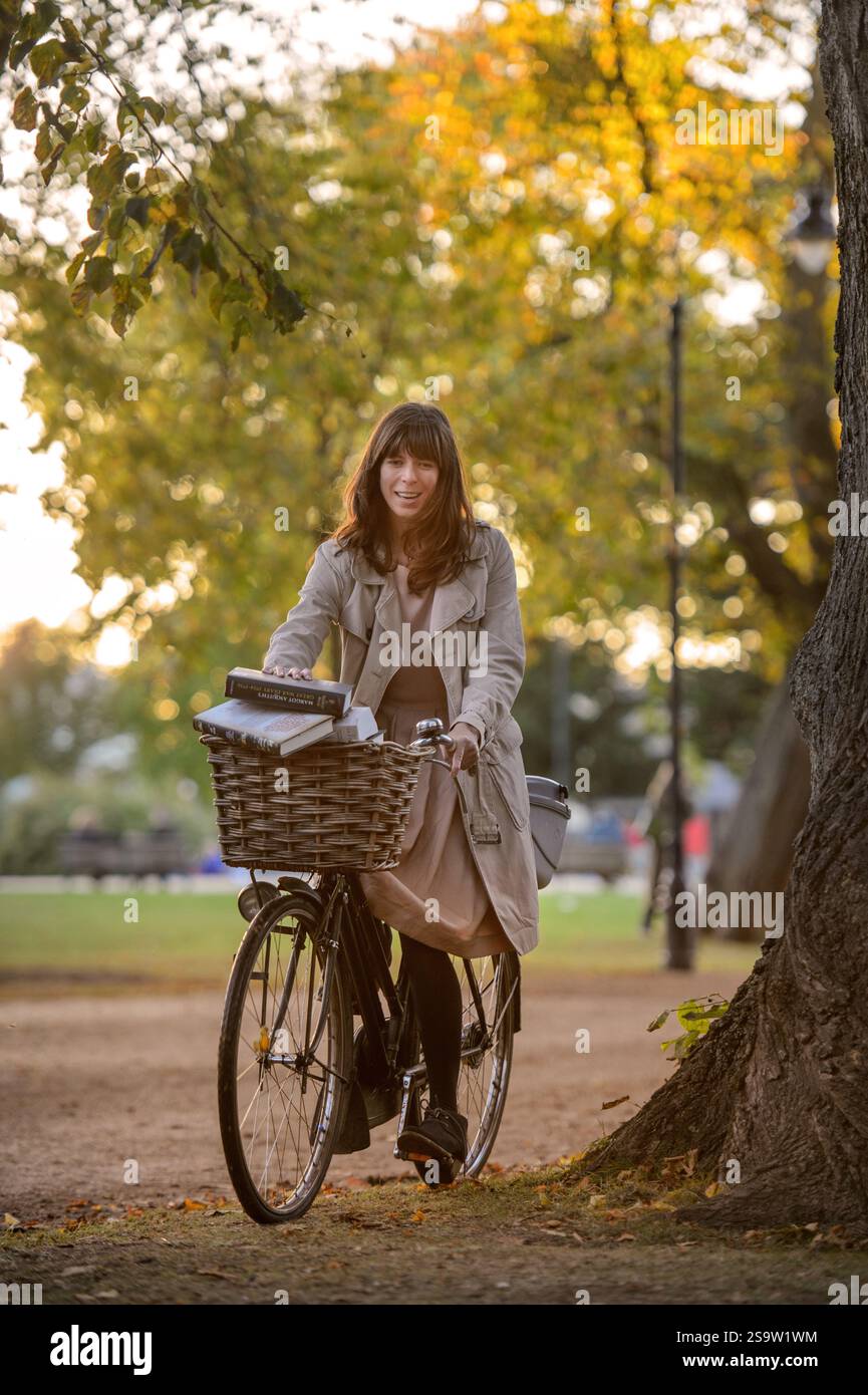 Lady on a vintage bike at a book festival, UK Stock Photo - Alamy