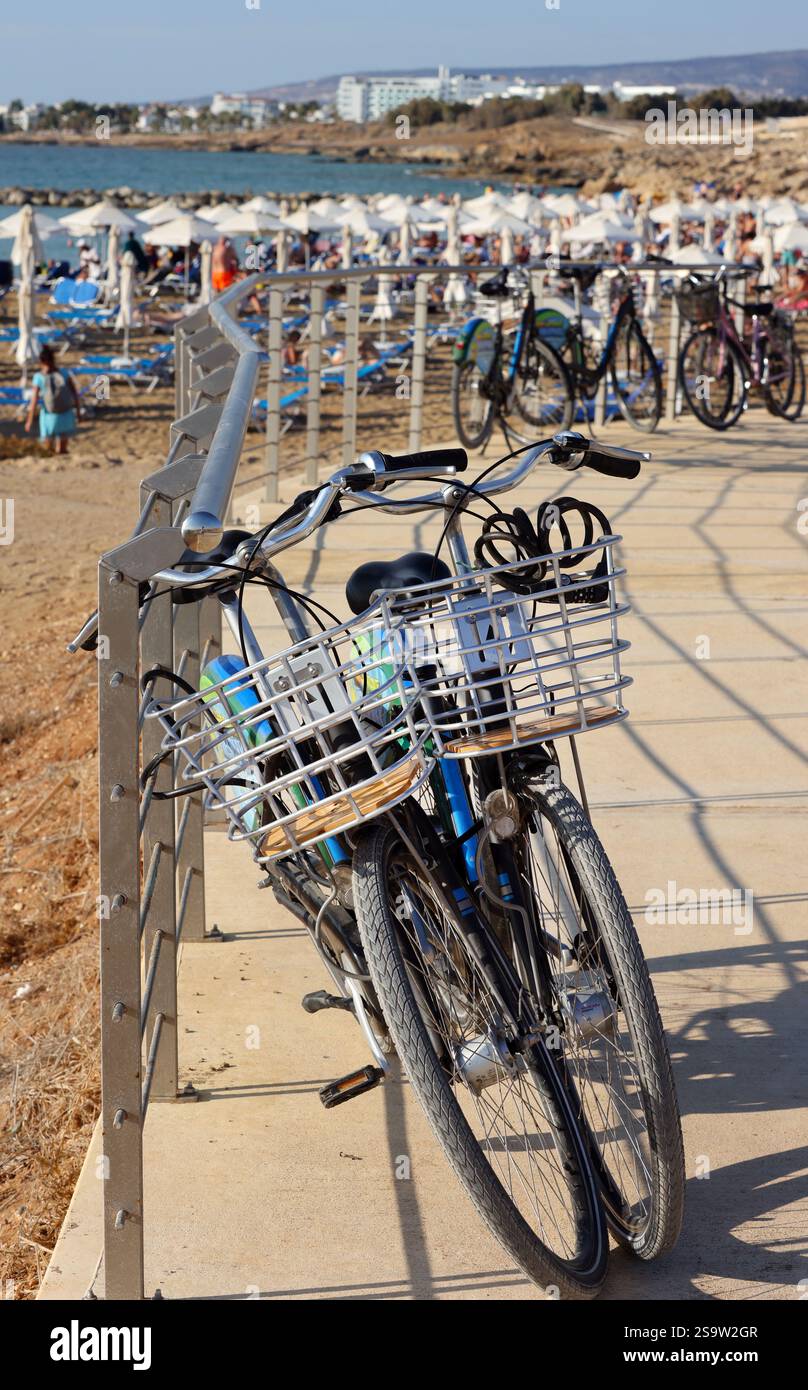 Bicycles attached to railings at the Venus Beach near Paphos, Cyprus. A ...