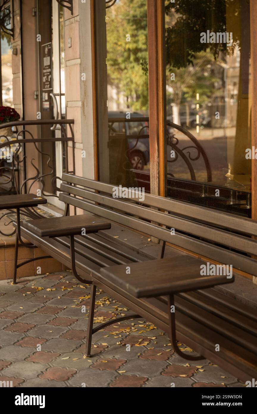 tables and benches near a street cafe Stock Photo - Alamy