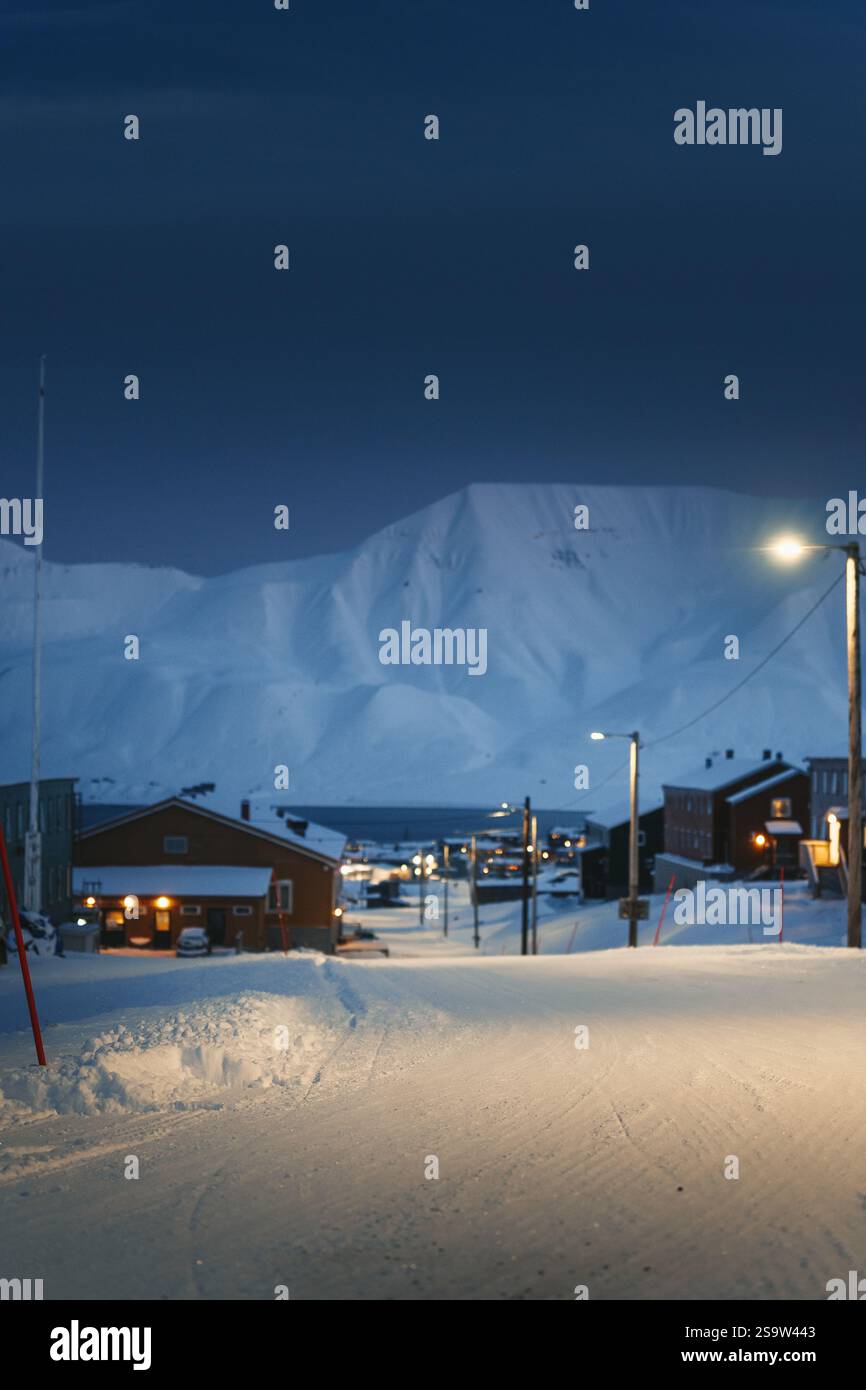 Polar night view of snowy mountain beyond Longyearbyen, Svalbard Stock ...