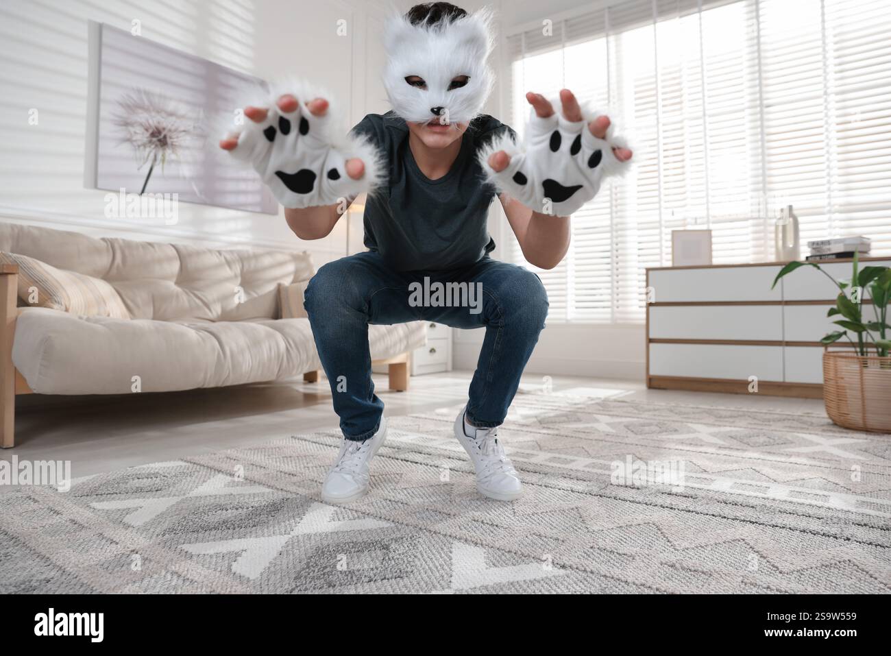 Quadrobics. Boy wearing cat mask and gloves at home Stock Photo - Alamy