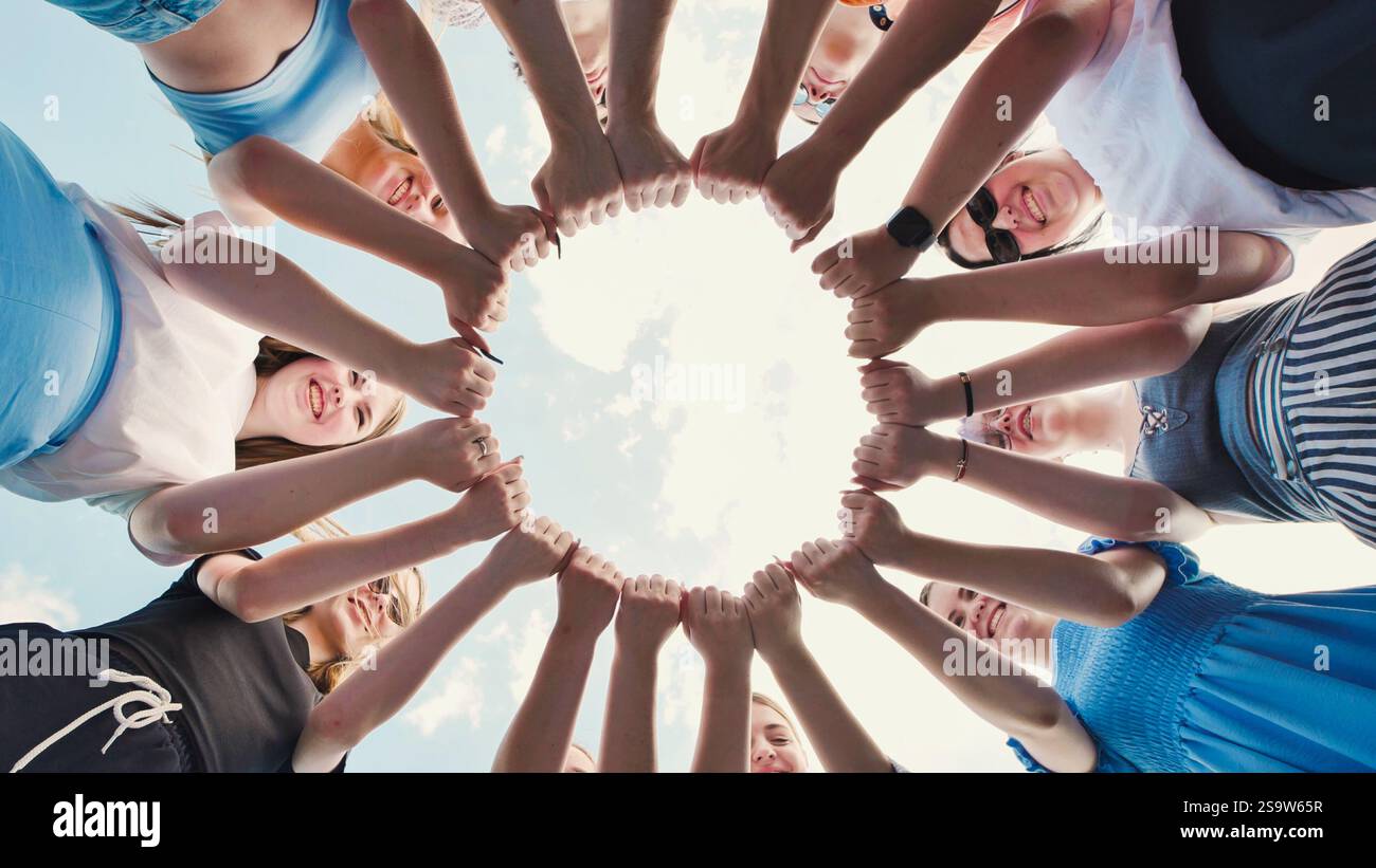 School friends joining hands in a circle, symbolizing unity, teamwork ...