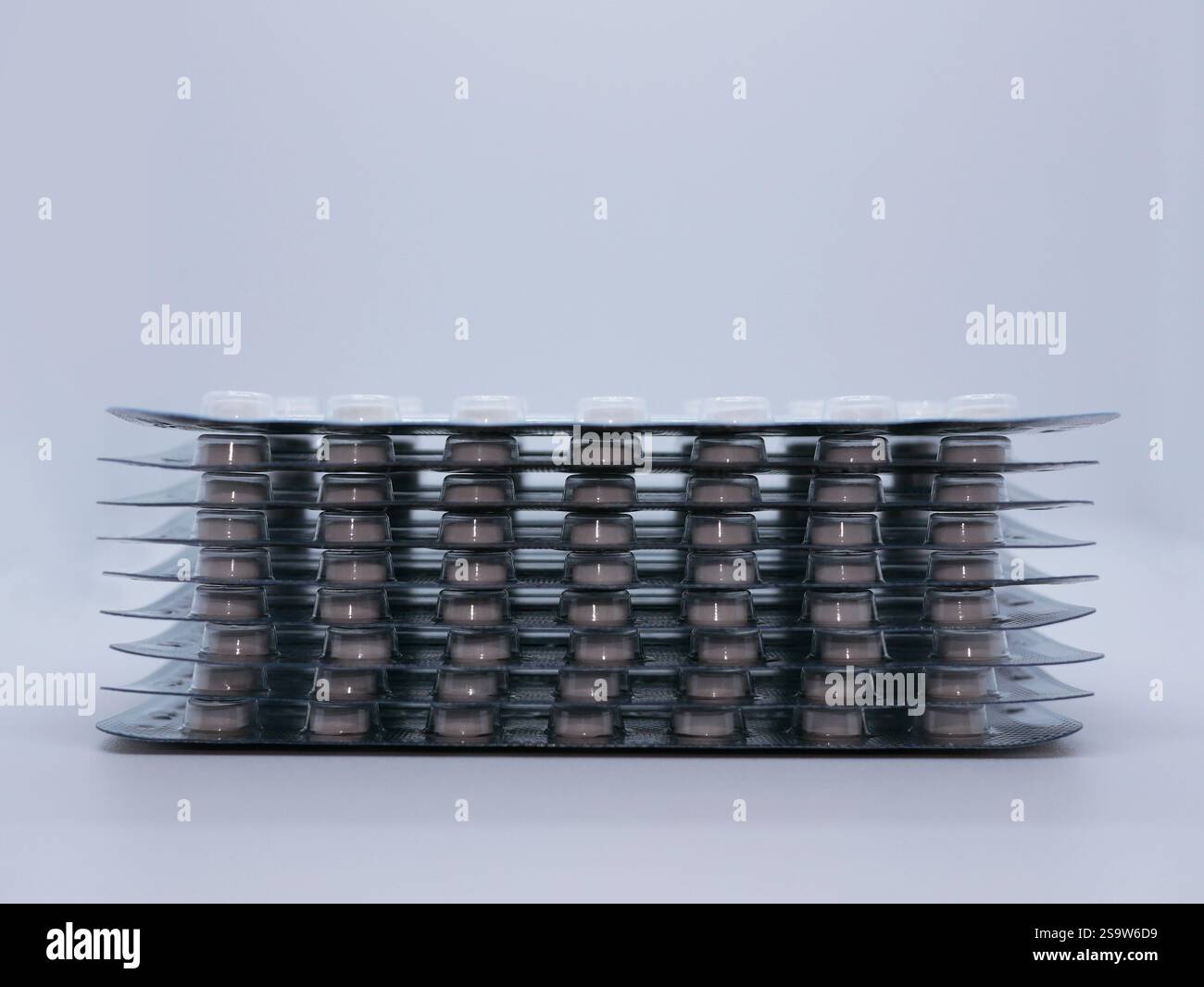 Stack of pill packs on white background with copy space. Medicine ...