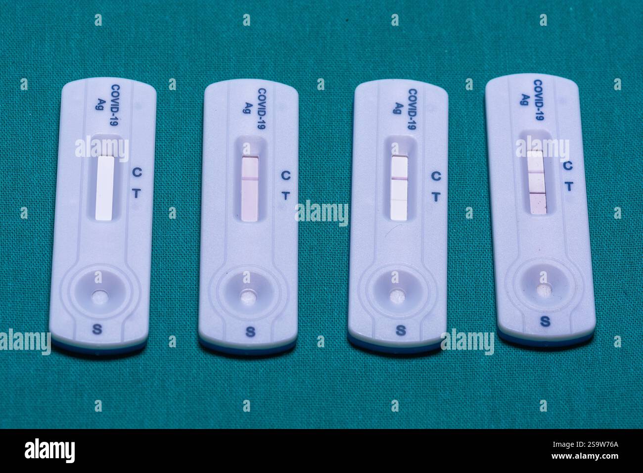 Set of COVID-19 rapid antigen test cassettes showing different results ...