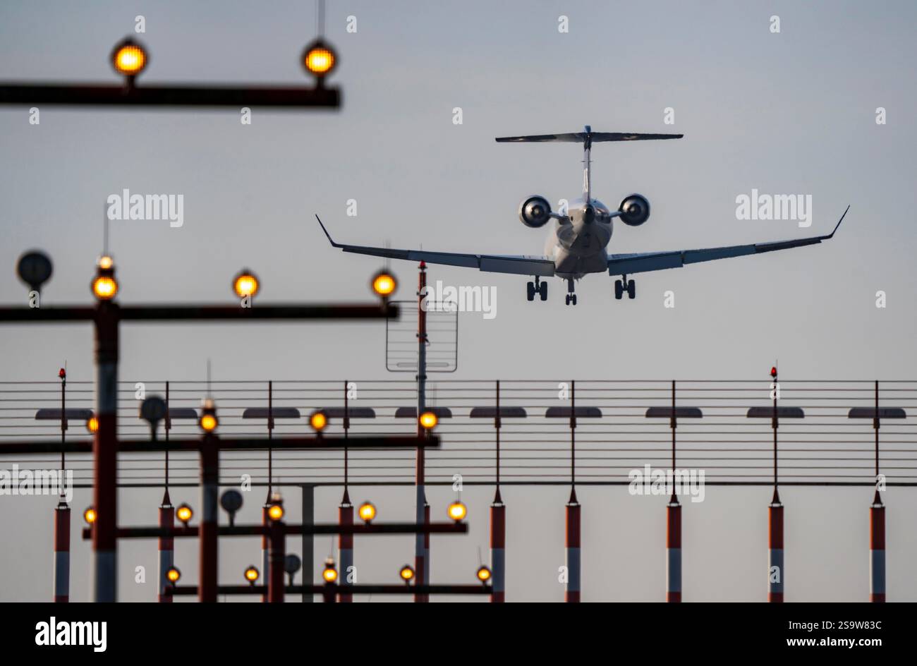 Aircraft on approach to the main south runway, 05R/23L, runway lighting ...