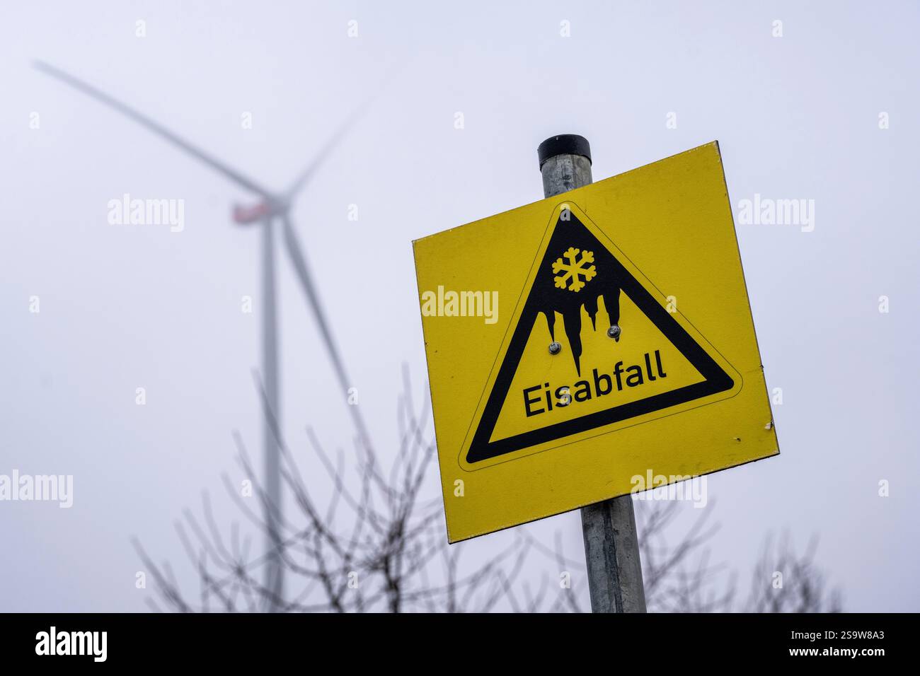 Sign warns of ice being dropped by wind turbines. Ice can form on the ...