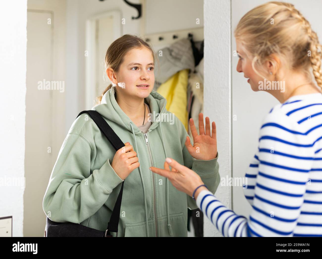 Girl saying goodbye to mother Stock Photo - Alamy
