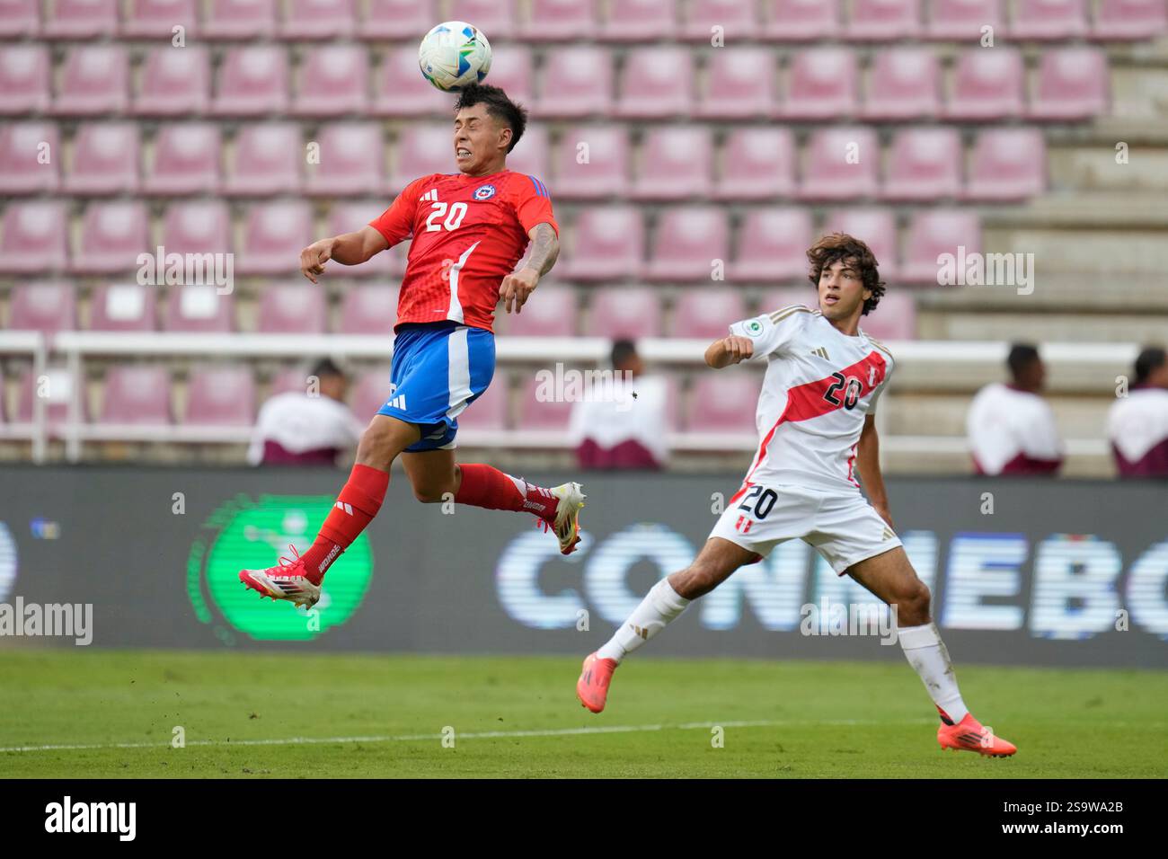 Chile's Felipe Faundez heads the ball alongside Peru's Bassco Soyer ...
