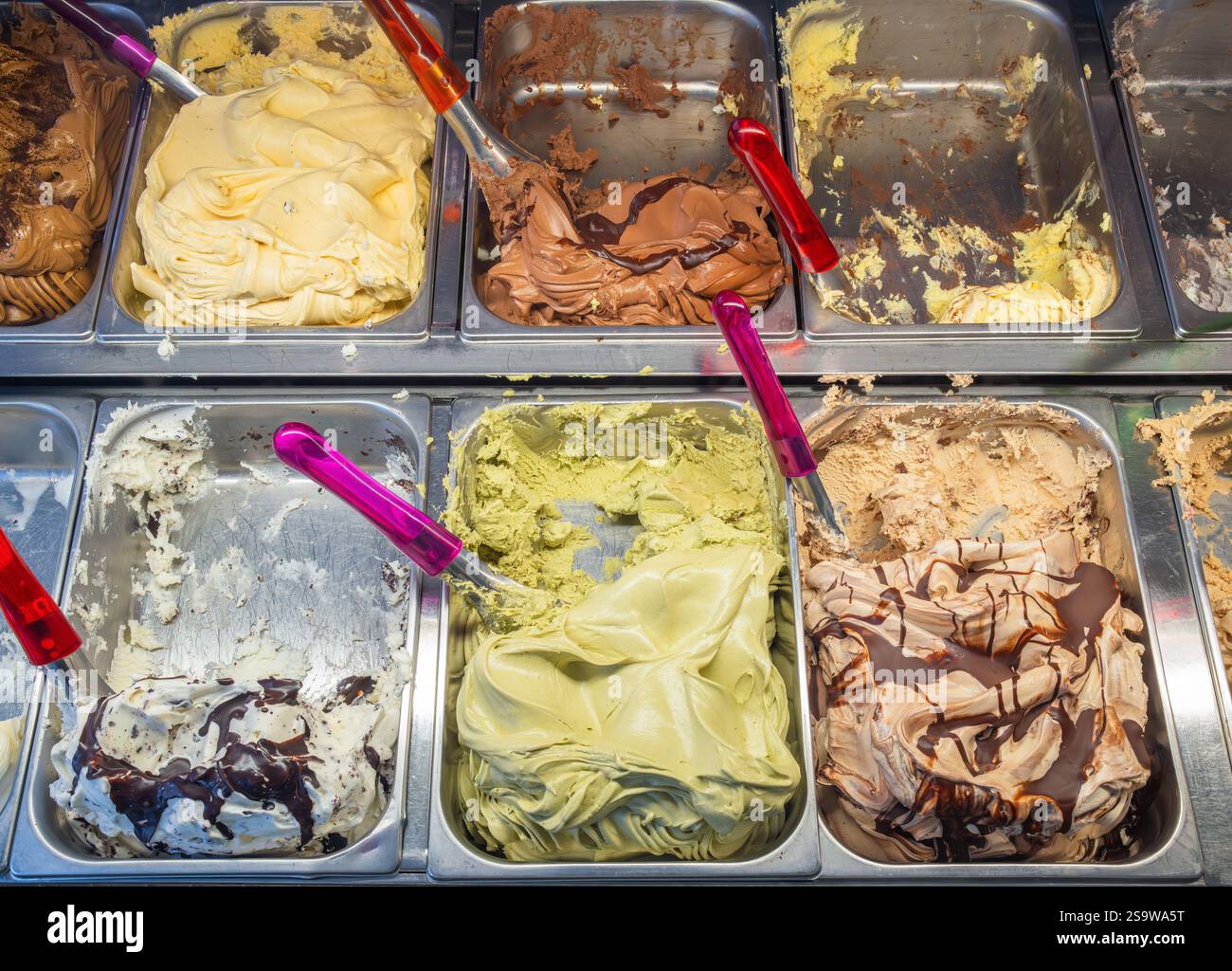 A variety of delicious gelato flavors are showcased in stainless steel ...