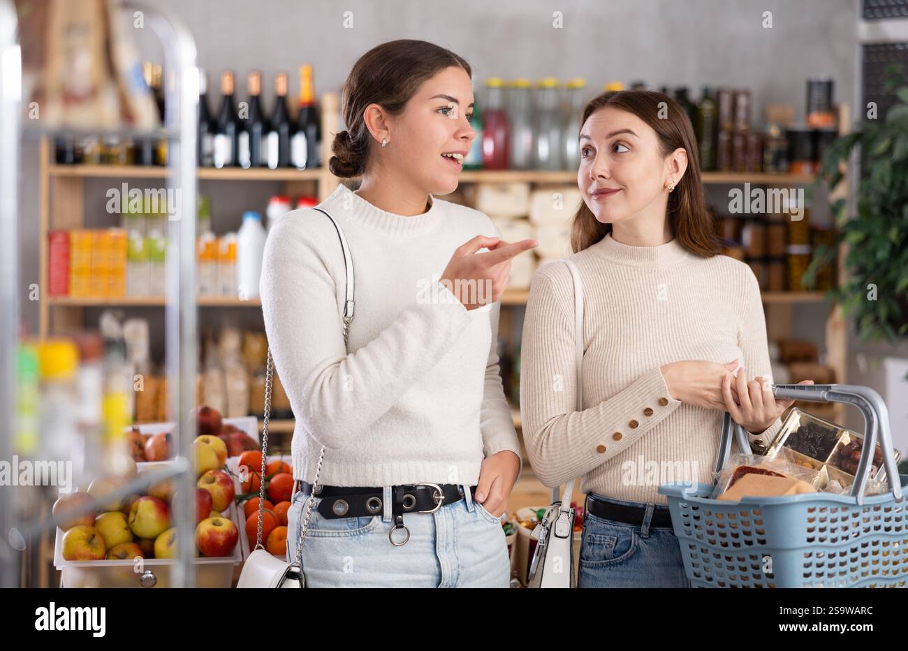 Two women shopping in a store Stock Photo - Alamy