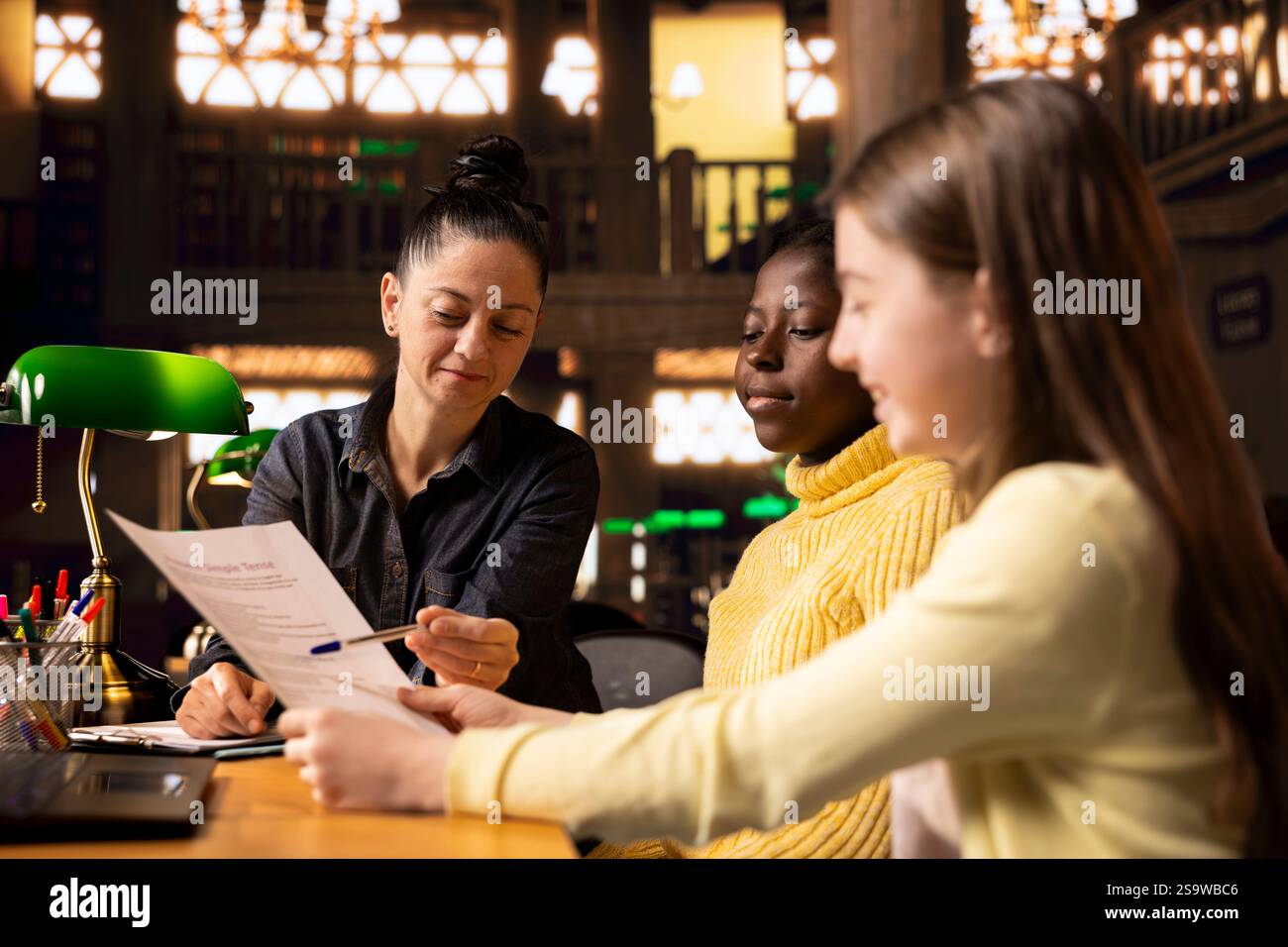 Female professor correcting students hi-res stock photography and ...