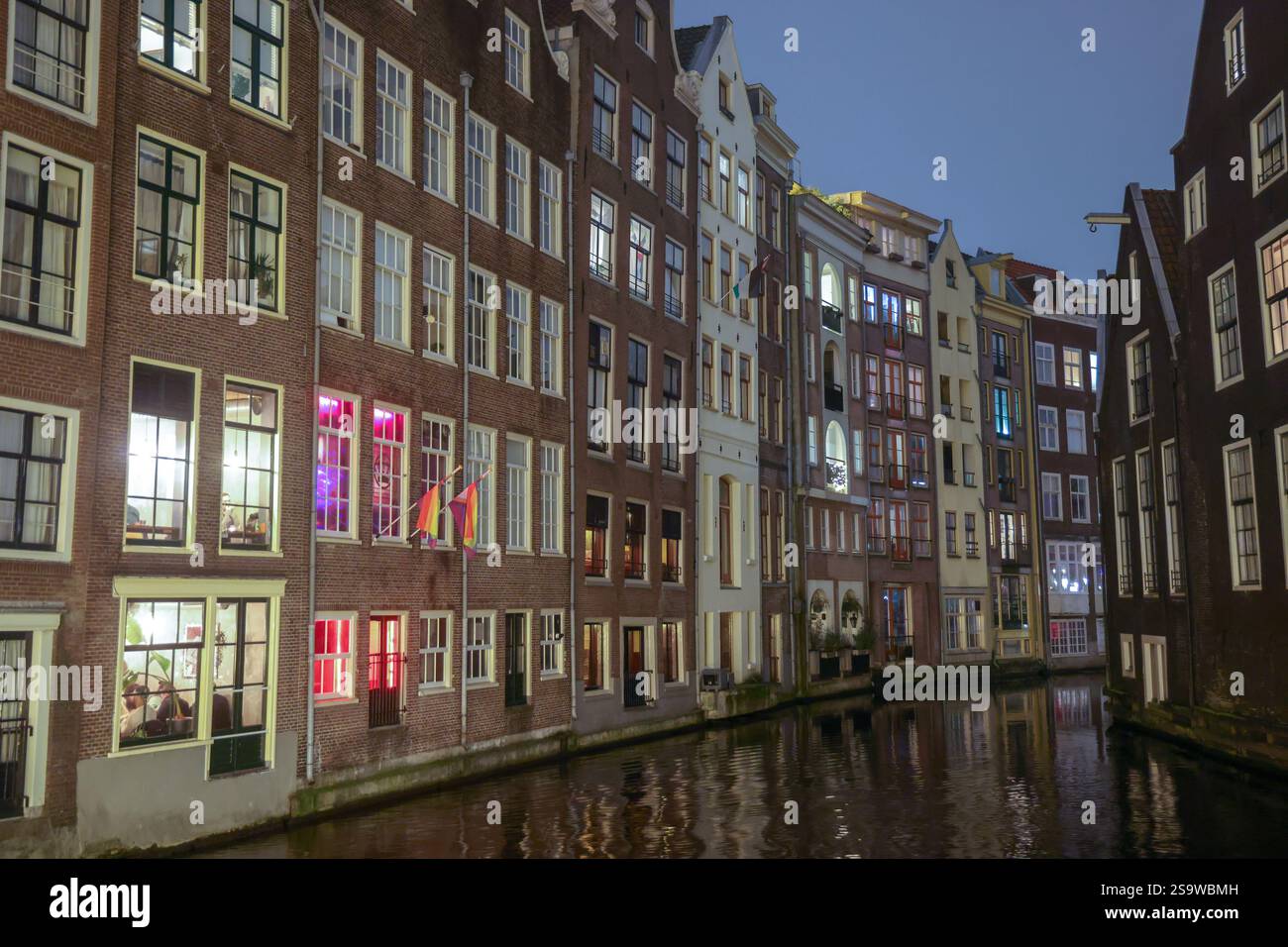 Nightview of canal houses with dutch gables and lit windows in the ...