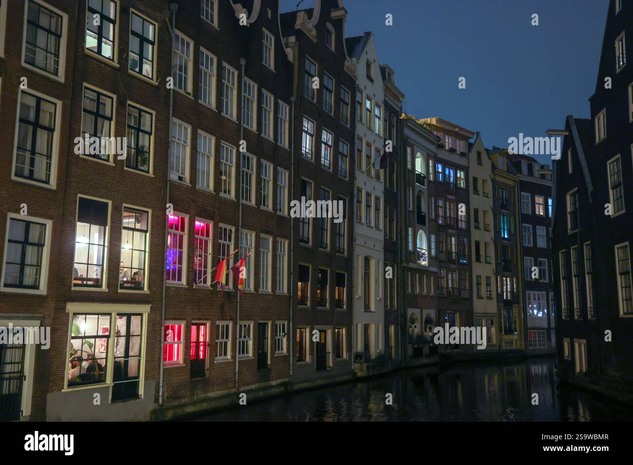 Nightview of canal houses with dutch gables and lit windows in the ...