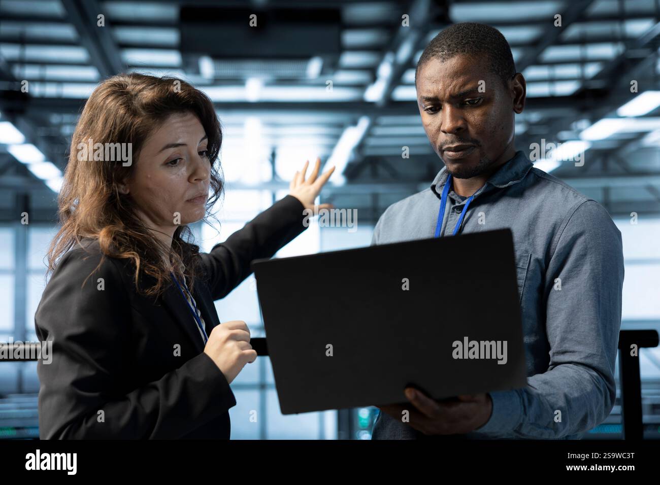 Computer Scientists In Data Center Automating Routine Maintenance Tasks With Laptop Executing