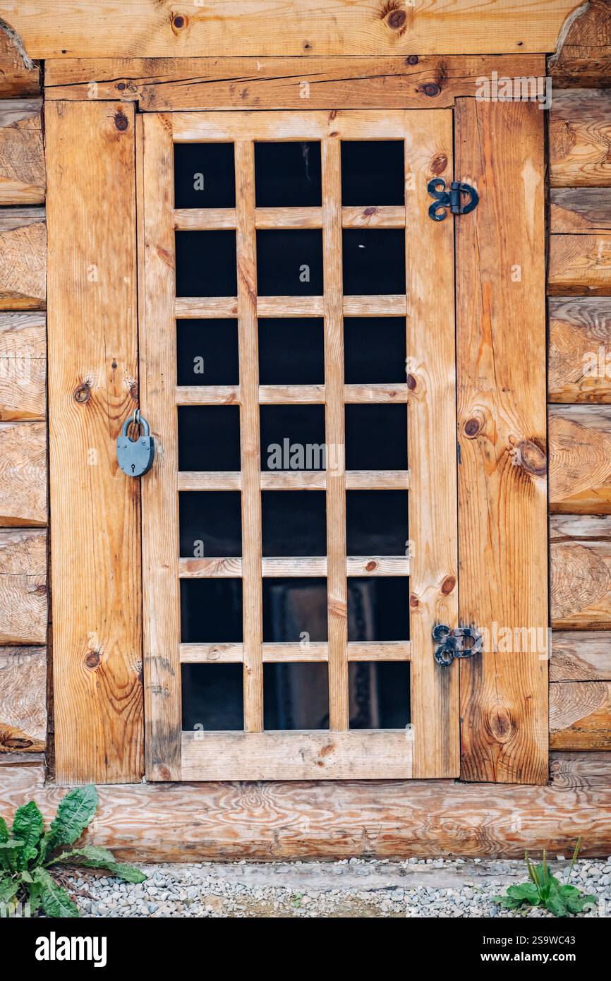 Locked wooden door with a barred window, attached to a traditional ...