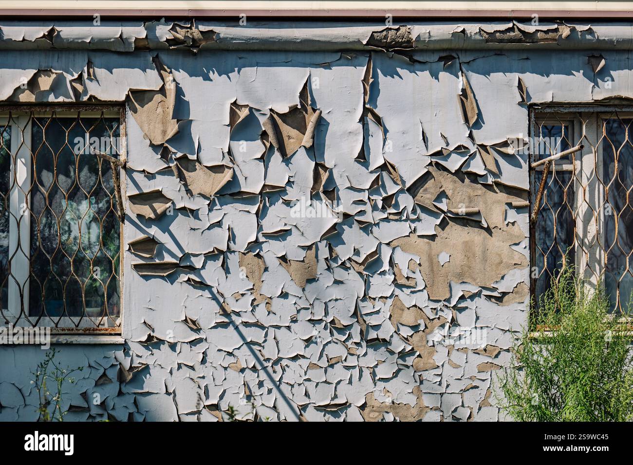 Weathered russian wall revealing crumbling paint, rusted metal grates ...