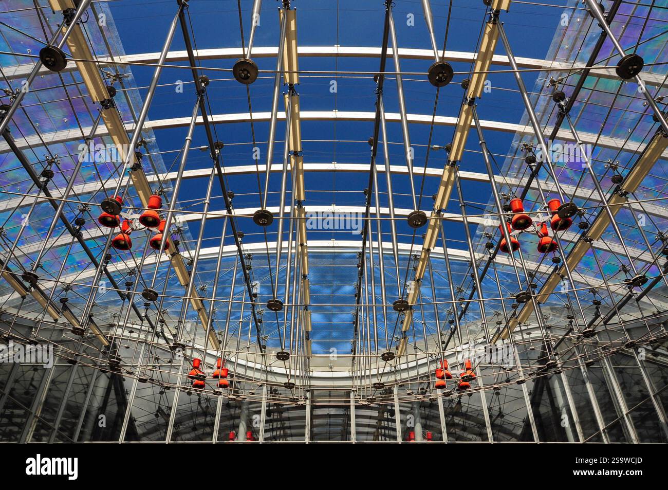 Glass and steel architecture with red orbs under blue sky Stock Photo ...