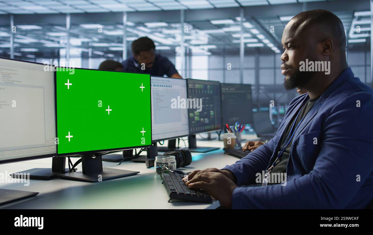 African american data center admin using mockup PC, maintaining company network infrastructure ...