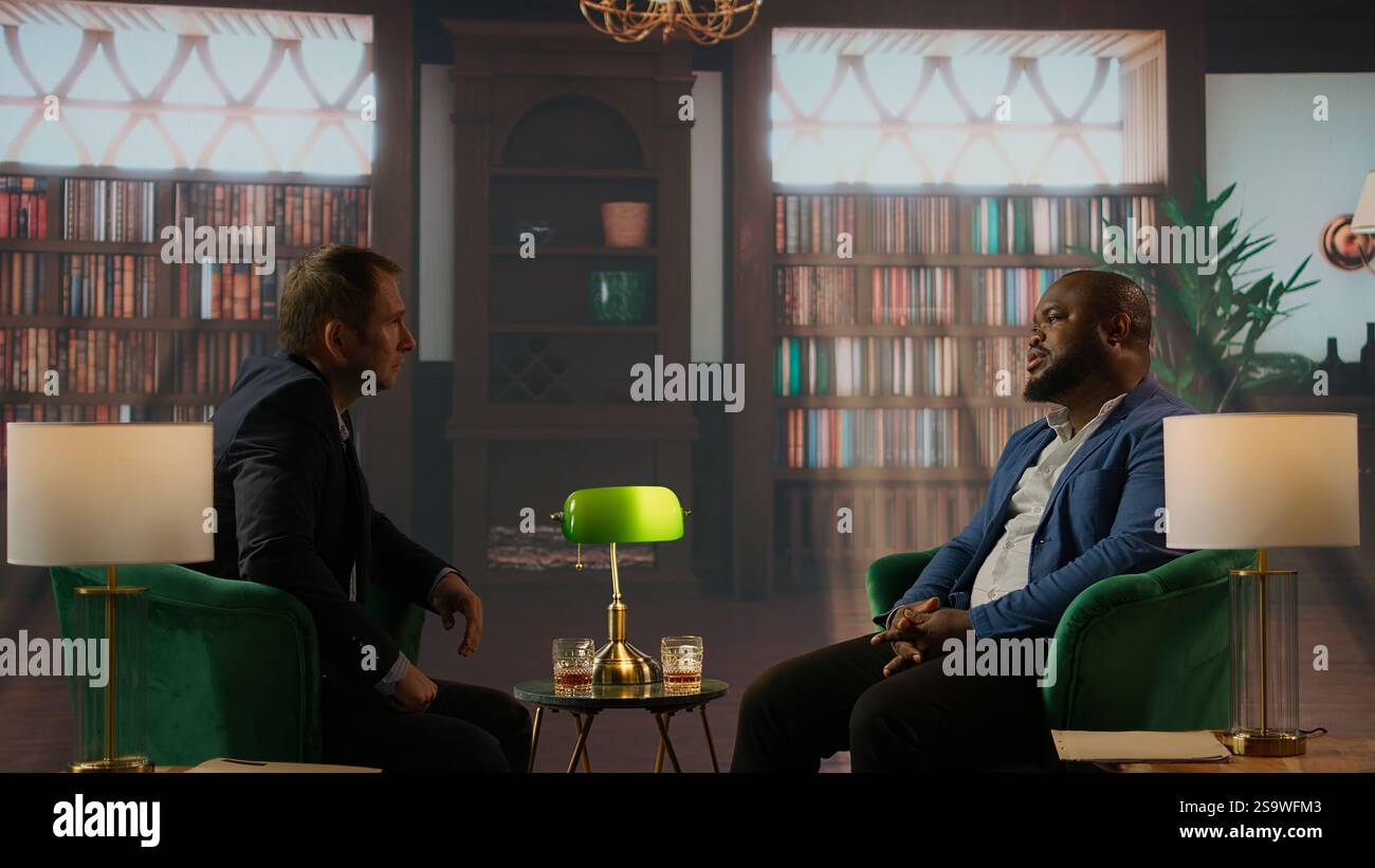 Confident gentlemen meeting in a classic elite club and negotiating ...
