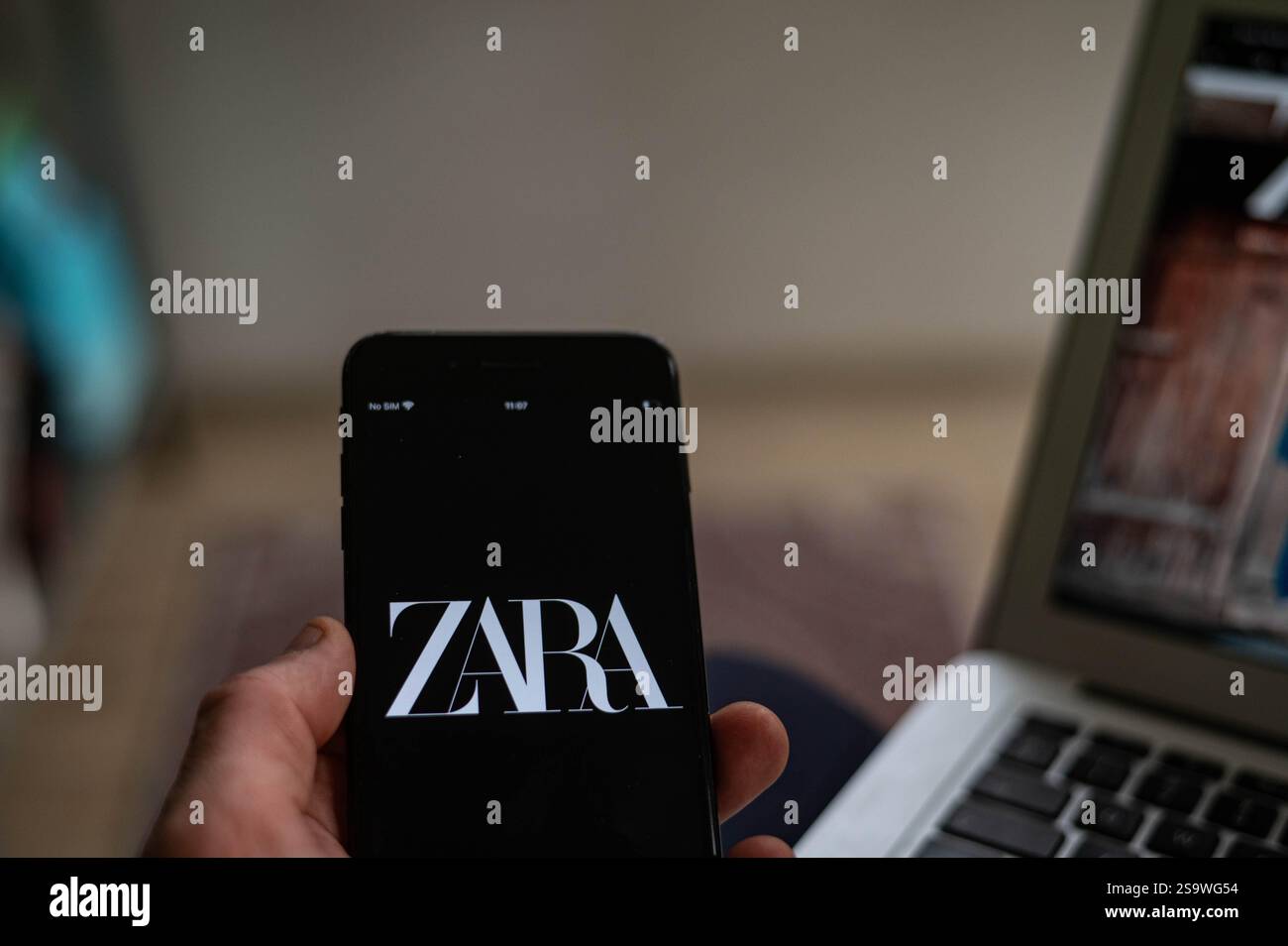 Zara logo on the screen of mobile phone. Fast fashion industry Stock ...