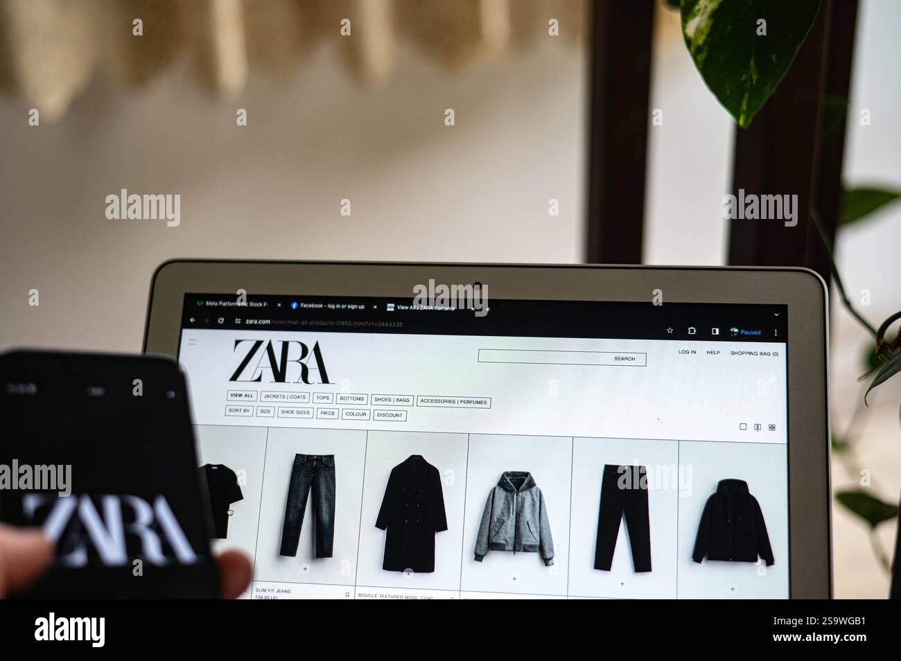 Zara logo on the screen of mobile phone. Fast fashion industry Stock ...