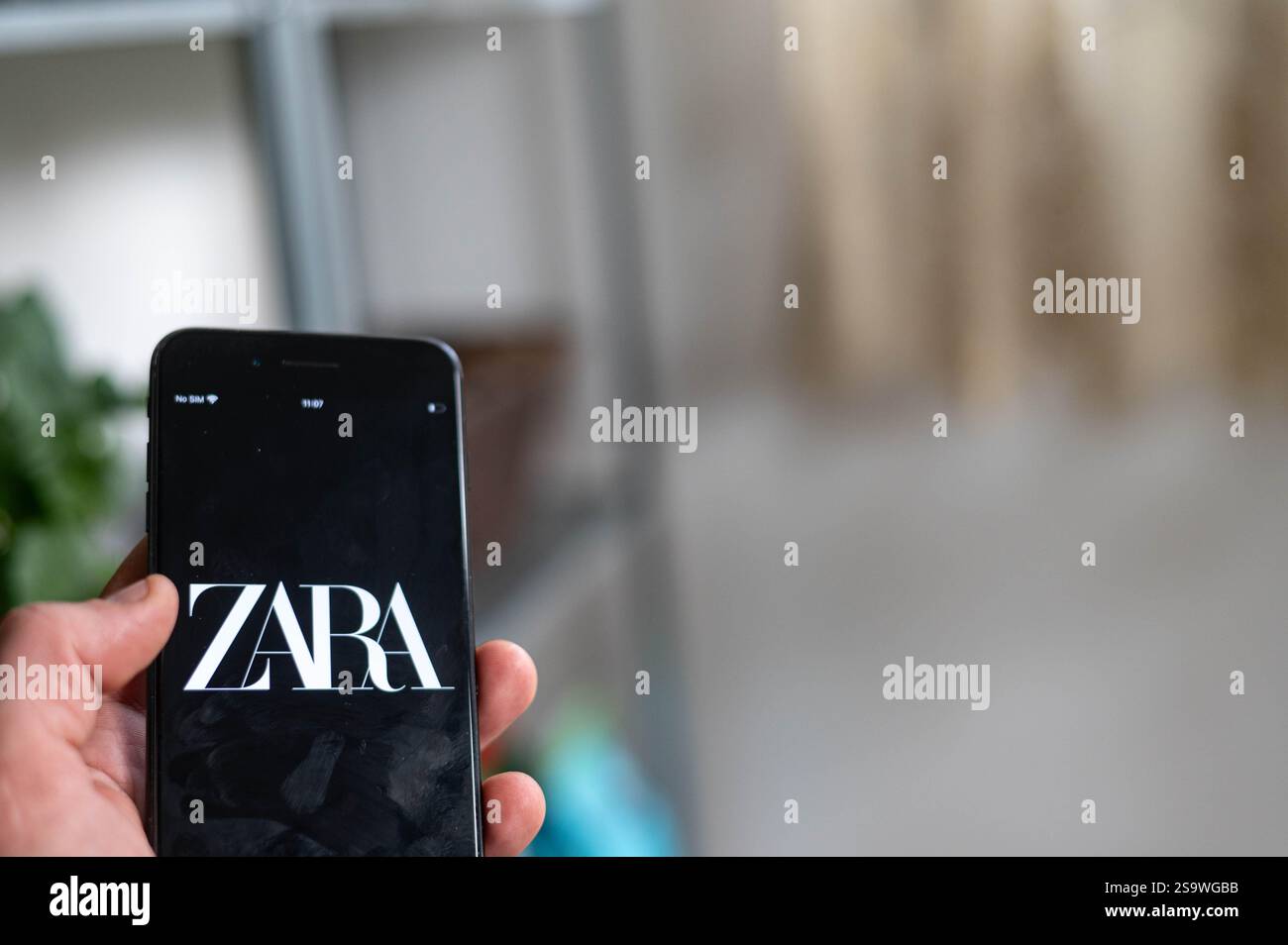 Zara logo on the screen of mobile phone. Fast fashion industry Stock ...