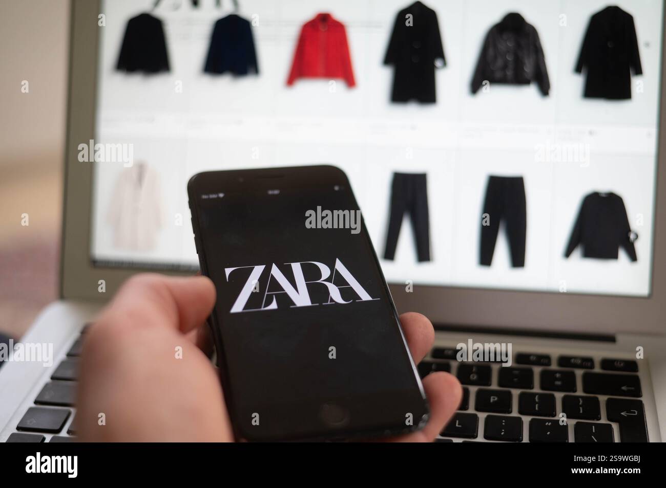 Zara logo on the screen of mobile phone. Fast fashion industry Stock ...