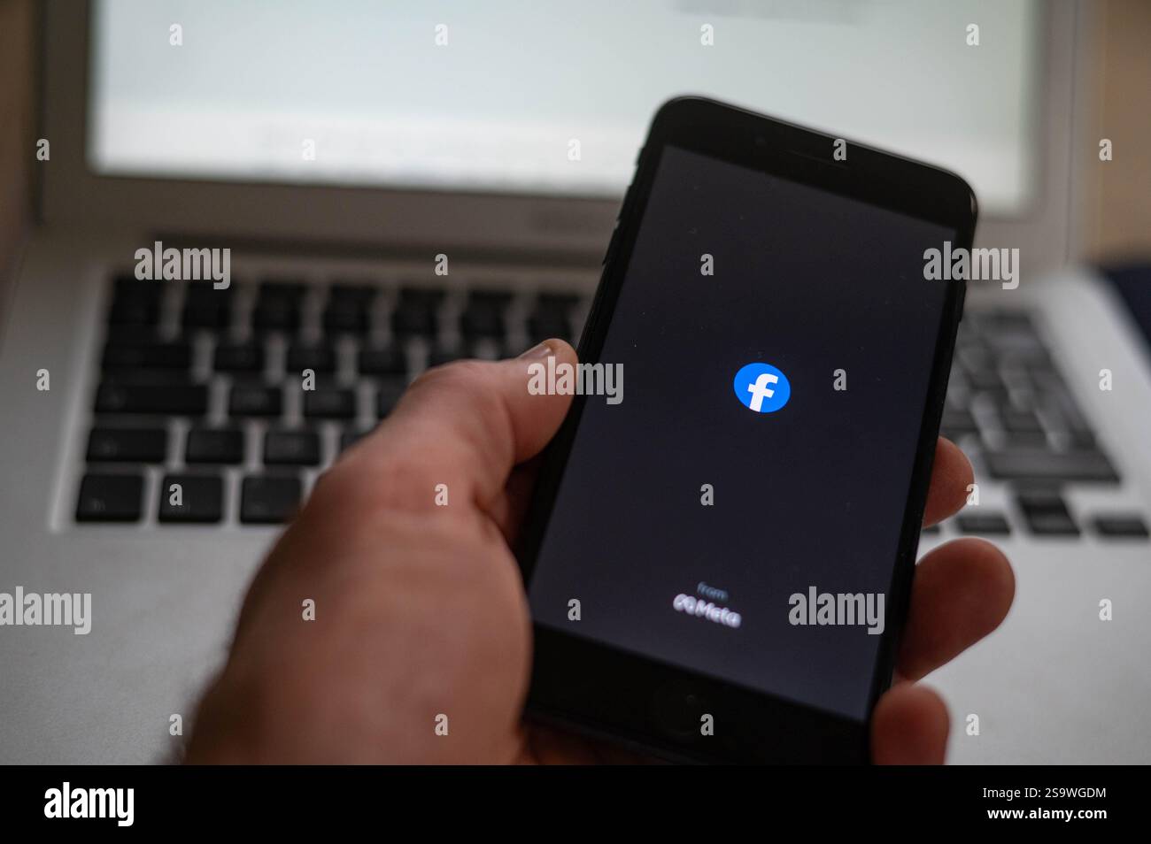A person is opening Facebook app on a phone. Facebook social media app ...
